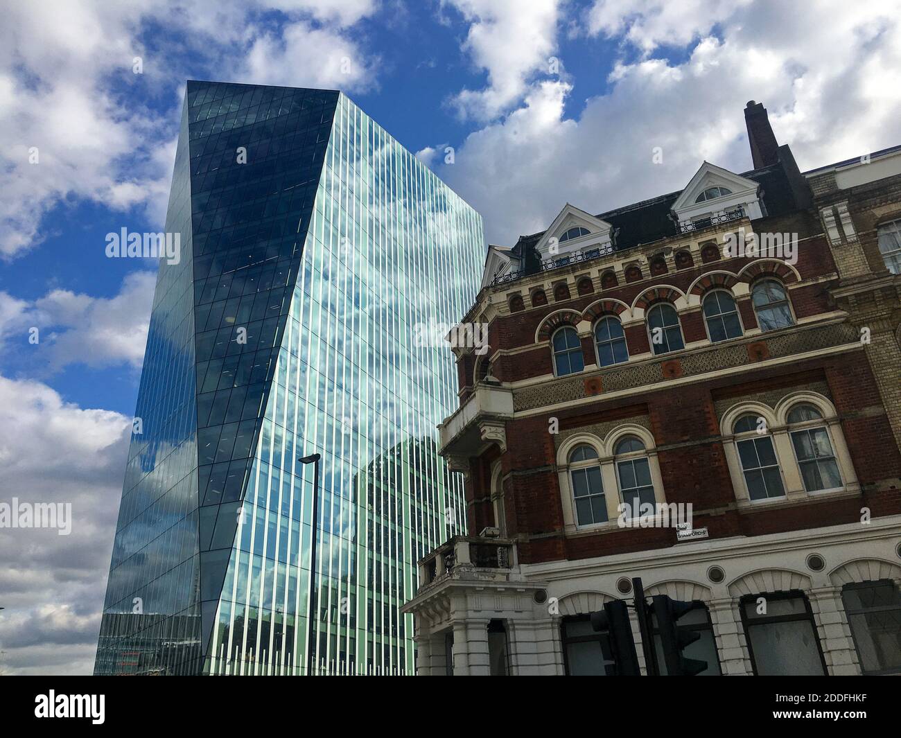 Skyscraper next to a traditional three story building Stock Photo - Alamy