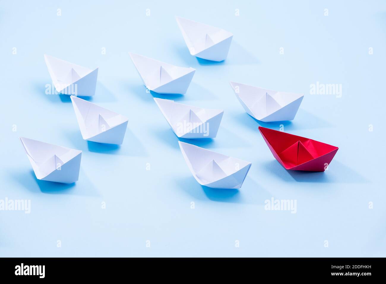 Red and white paper boats. Concept of leadership boats for teamwork ...