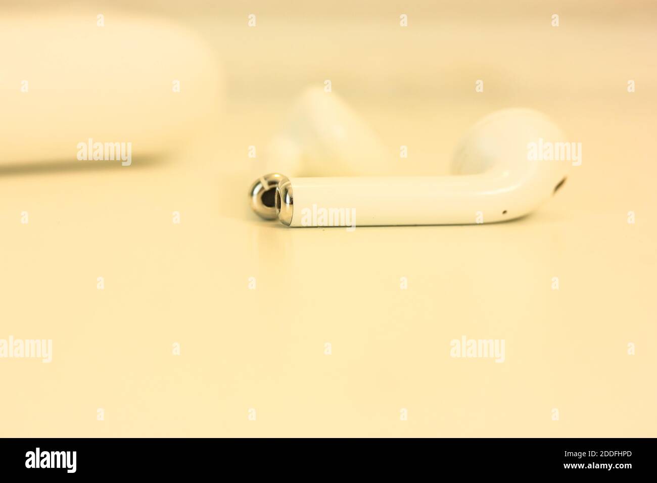 White airpods headphones on a white table, a device for listening to ...