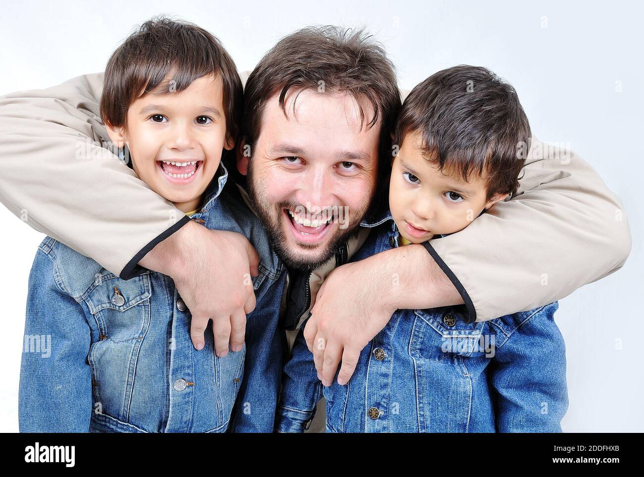 Hugging, father and two sons isolated Stock Photo - Alamy