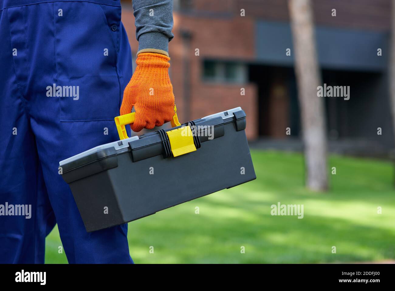 Close up construction worker carrying tool box hi-res stock photography ...