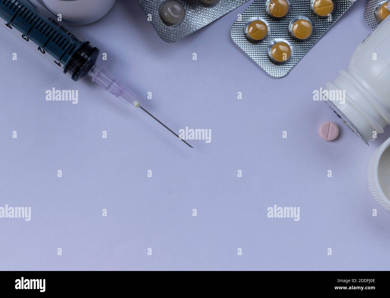 top view of injection syringe, bottle and tablets on white background ...