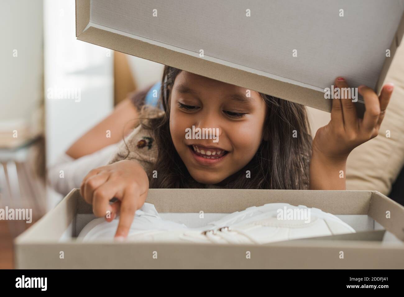 A framed photo of a cute girl opening a box Stock Photo - Alamy