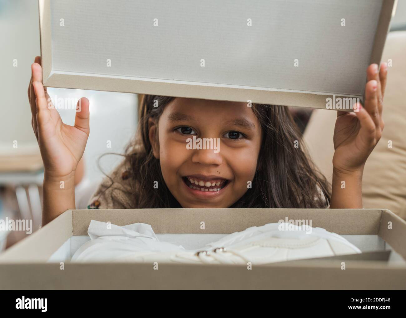 A framed photo of a cute girl opening a box Stock Photo - Alamy