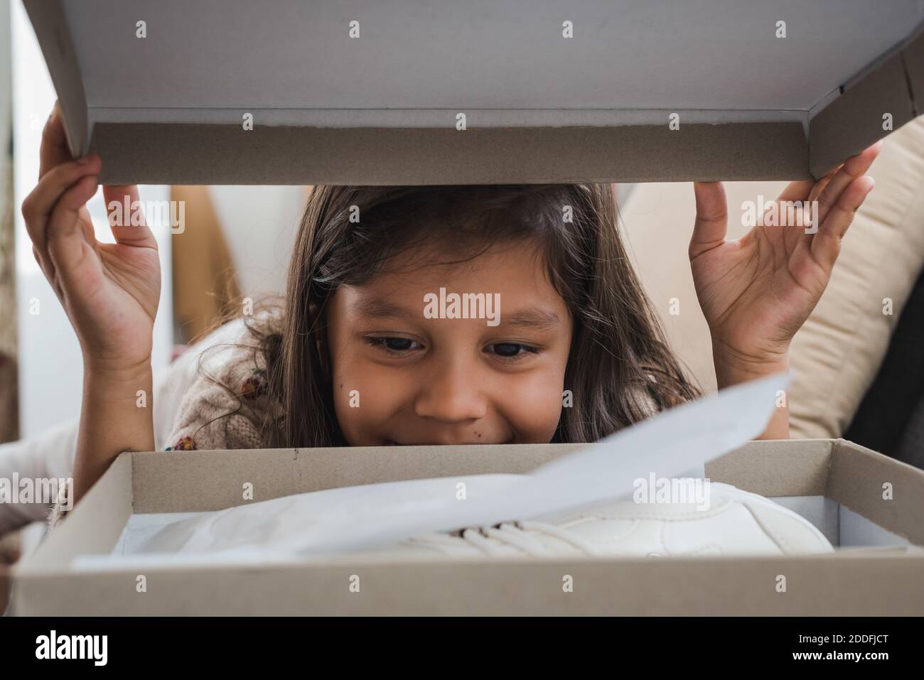 A framed photo of a cute girl opening a box Stock Photo - Alamy