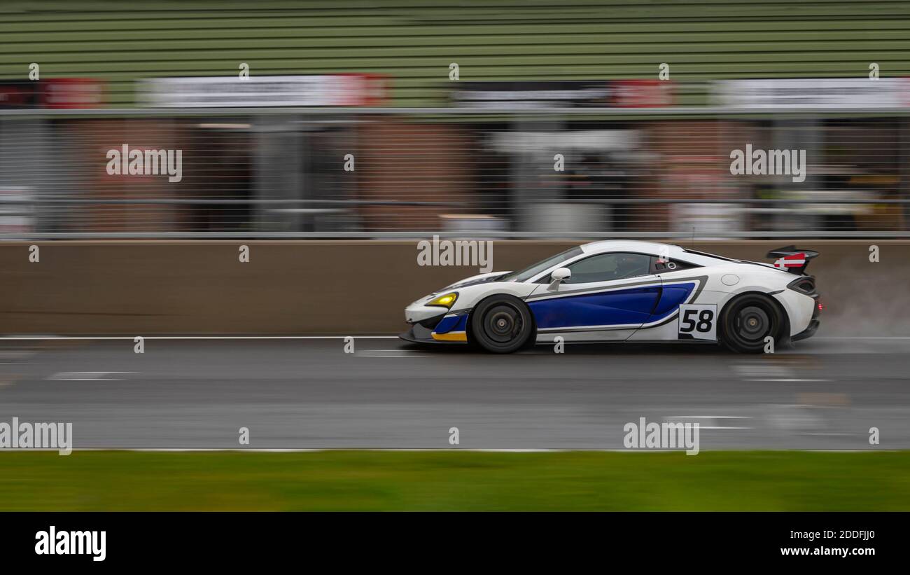 A panning shot of a racing car as it circuits a track Stock Photo - Alamy