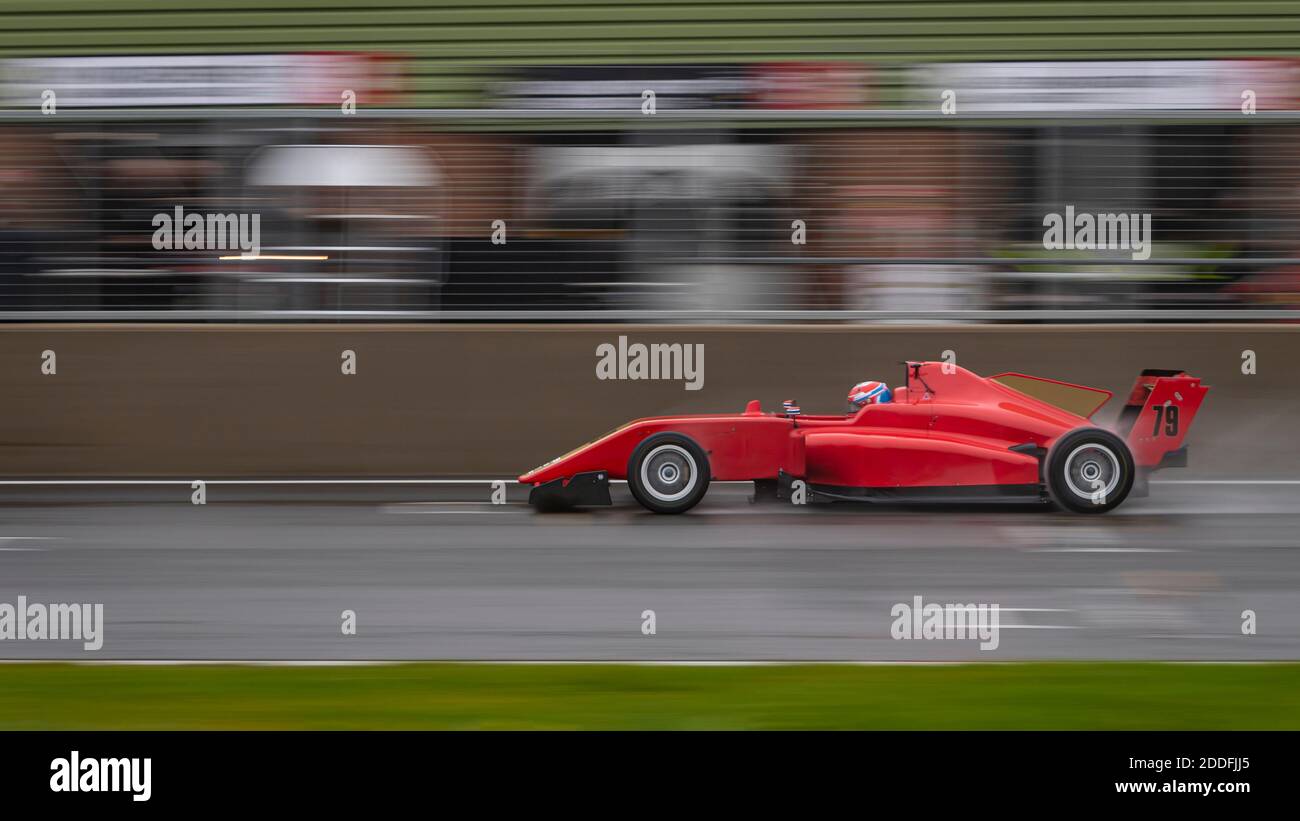 A panning shot of a racing car as it circuits a track Stock Photo - Alamy