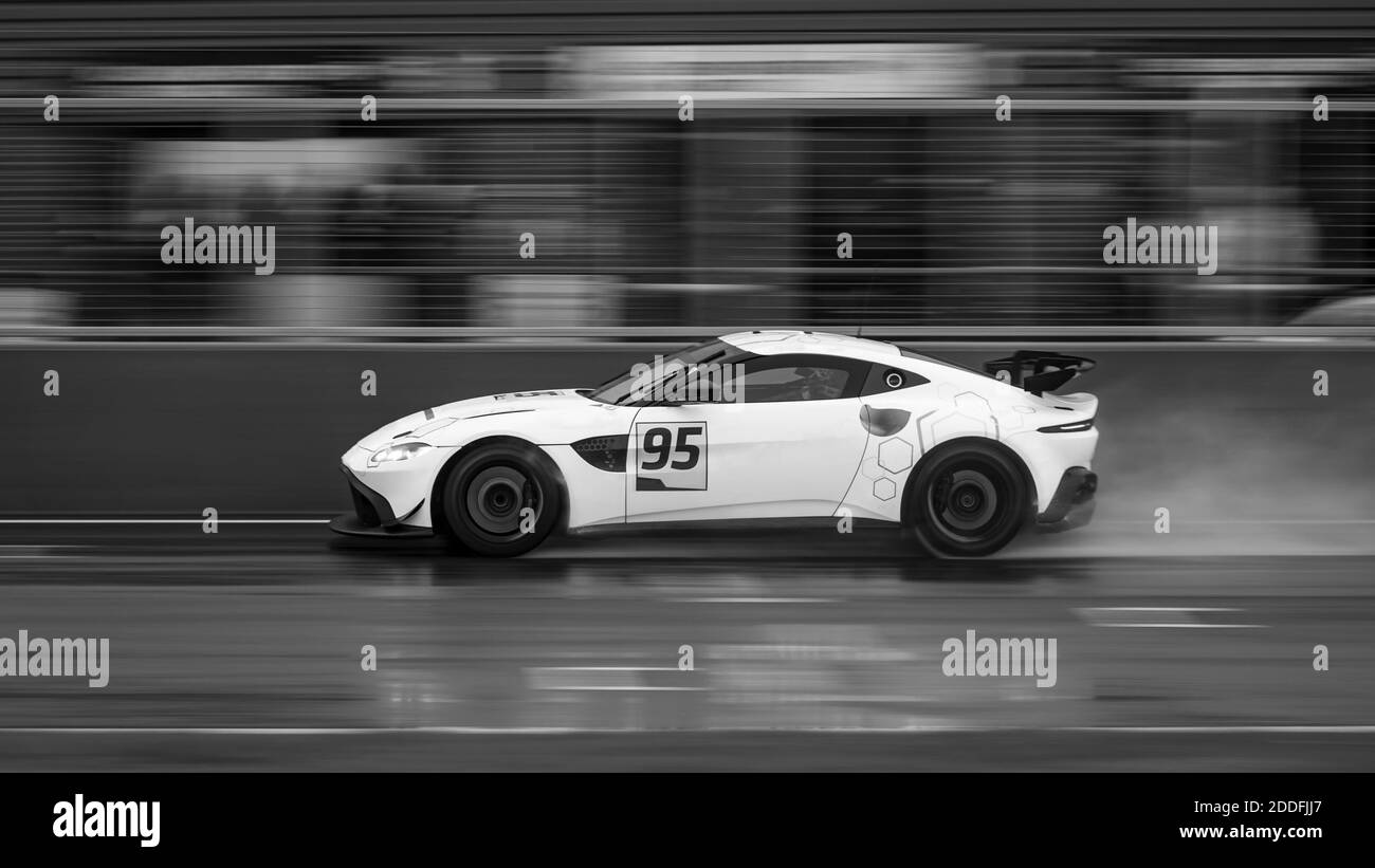 A panning shot of a racing car as it circuits a track Stock Photo - Alamy