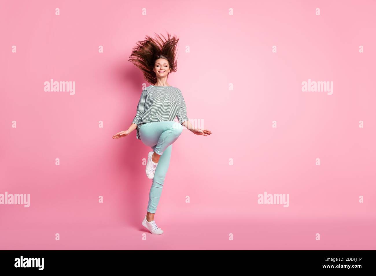 Full size photo of optimistic nice girl jumping leg up wear shirt blue ...