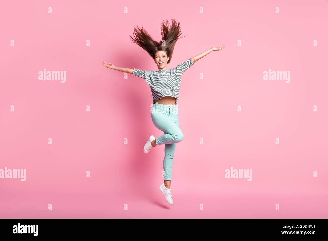 Full size photo of optimistic astonished girl jumping hands up wear ...