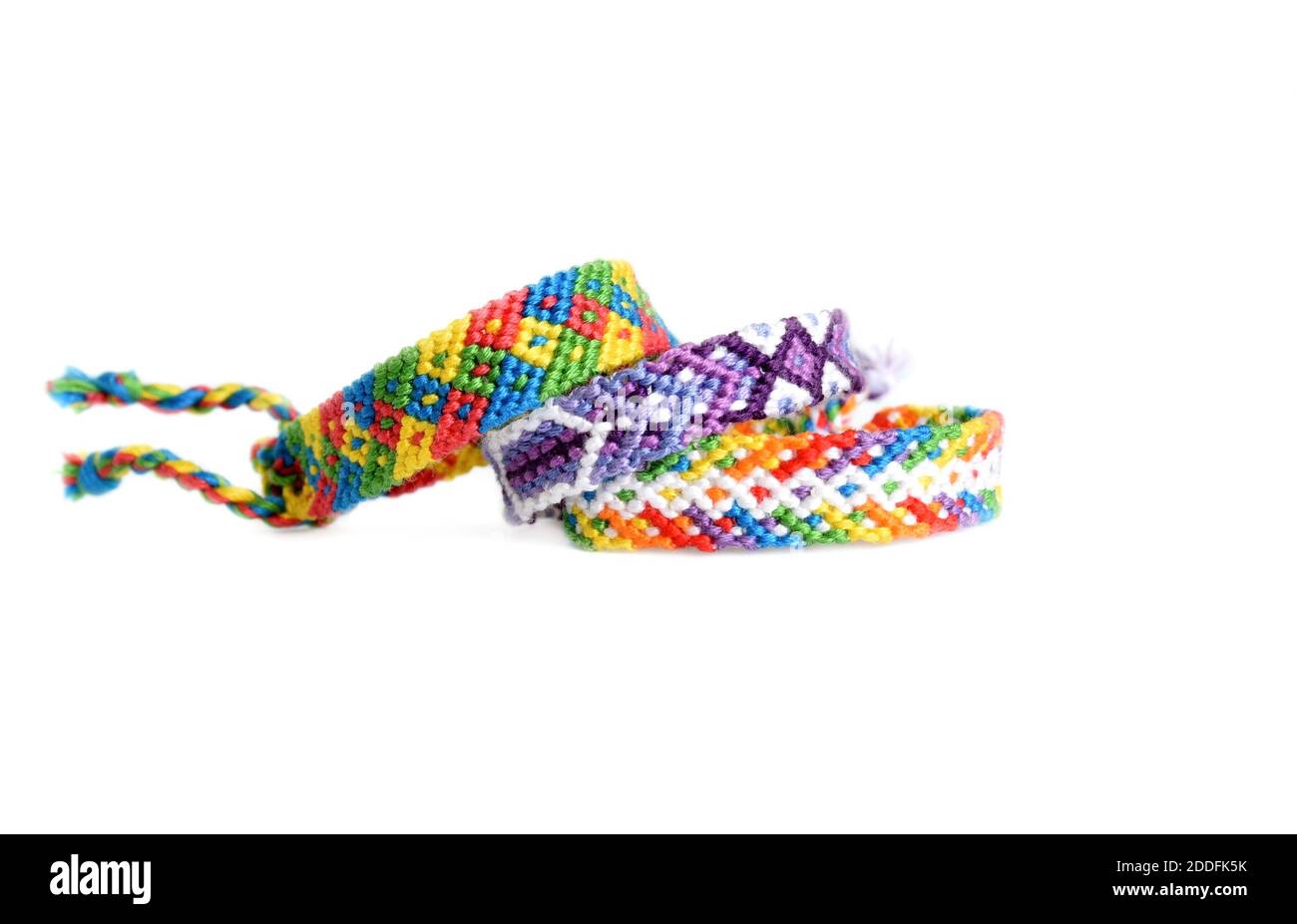 Selective focus of tied woven friendship bracelets with bright colorful ...