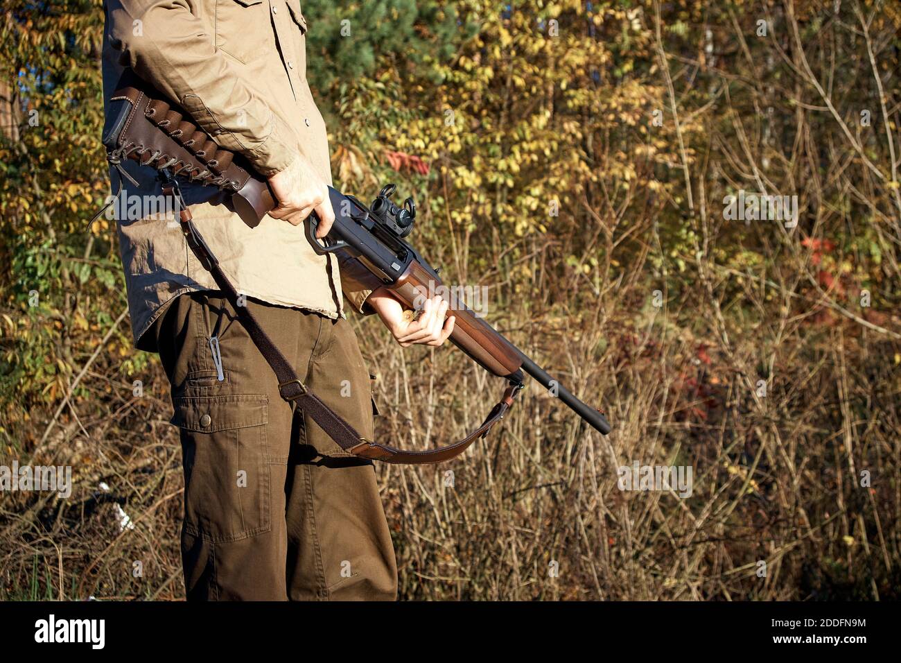 Hunter hunting in the forest with a hunting rifle. A man with a gun ...