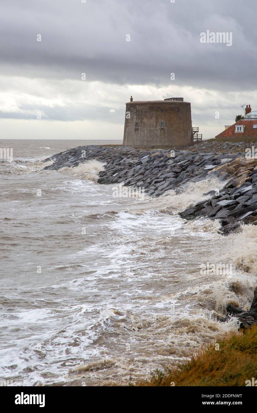 Winter storm clouds wave erosion rock armour protecting Martello tower ...