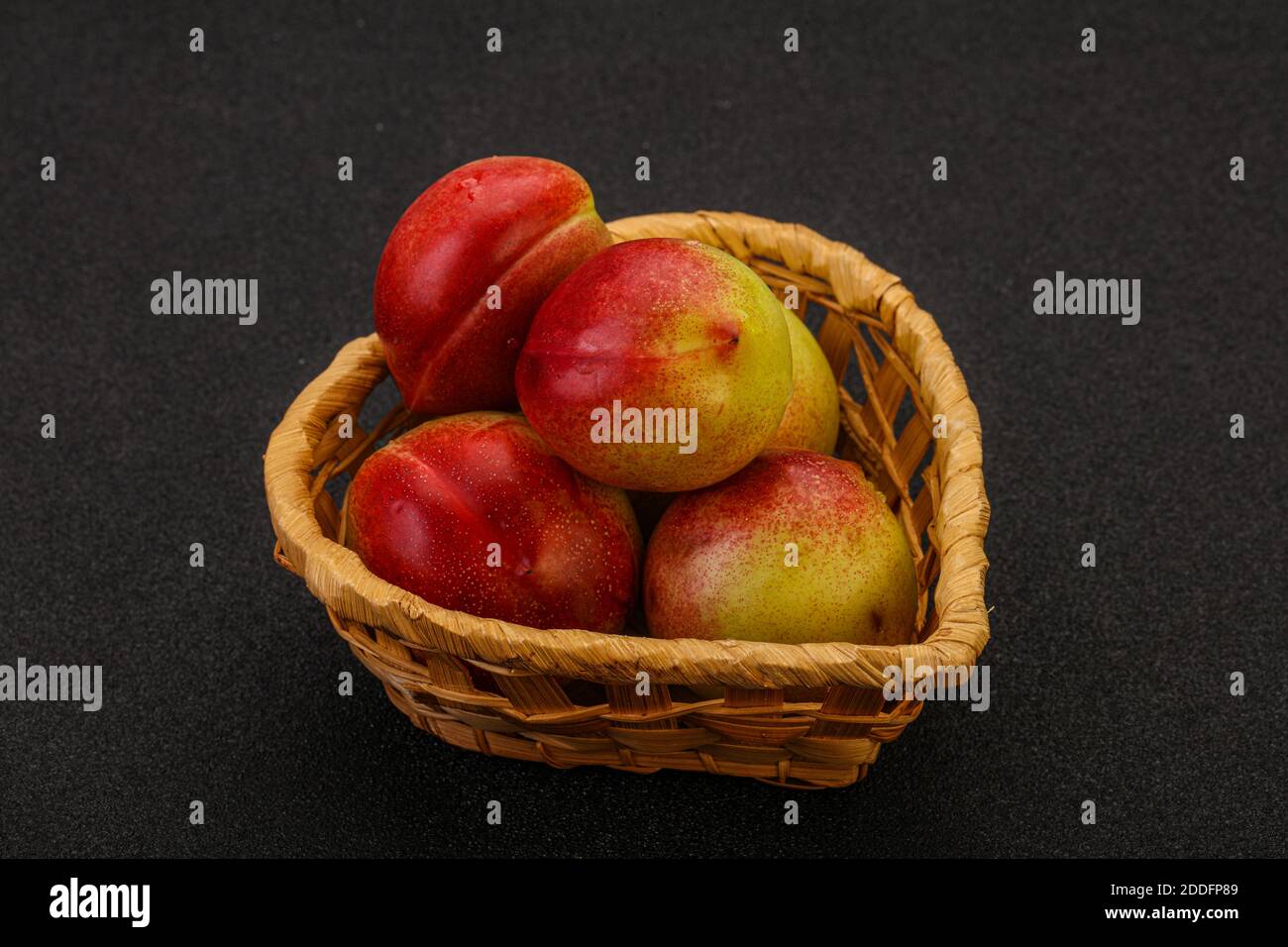 Sweet small green nectarines in the basket Stock Photo - Alamy