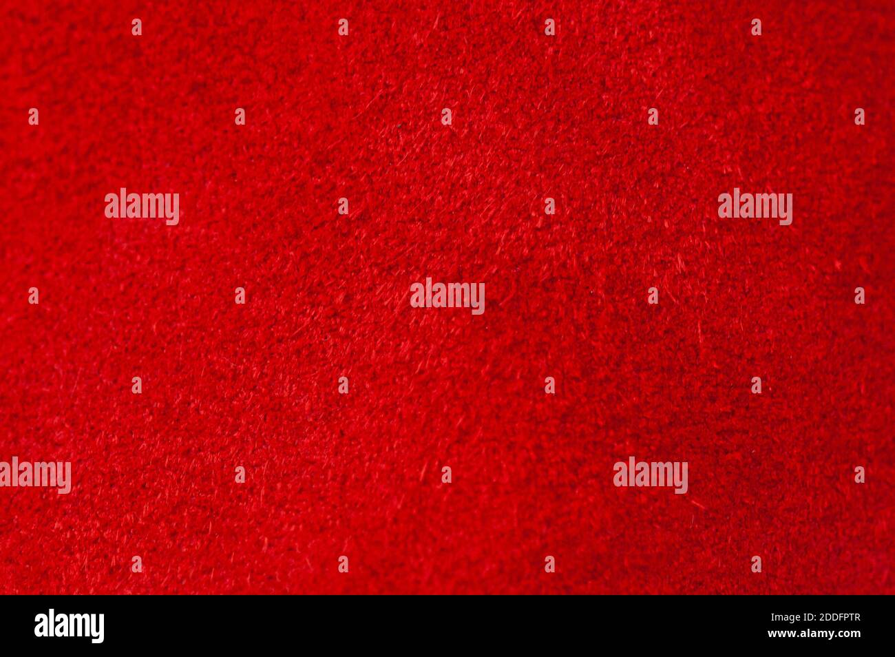 Red matte background of suede fabric, closeup. Velvet texture of ...