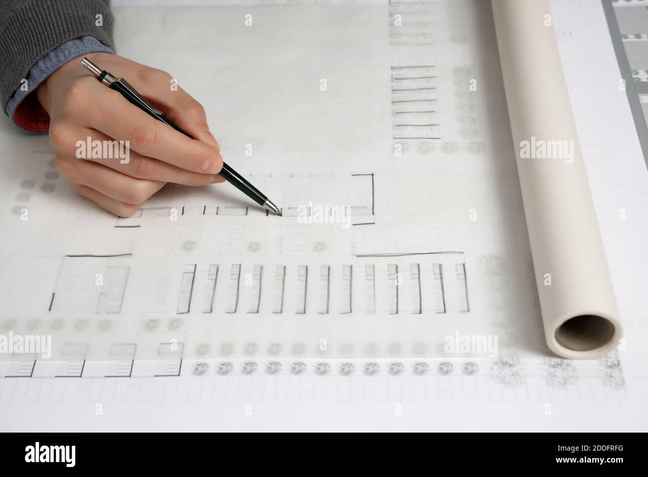 Architect hand drawing building plan sketch with mechanical pencil ...