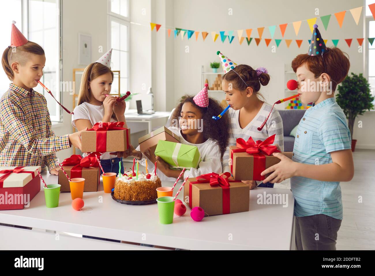 Group of children give presents to their afro friend, who is ...