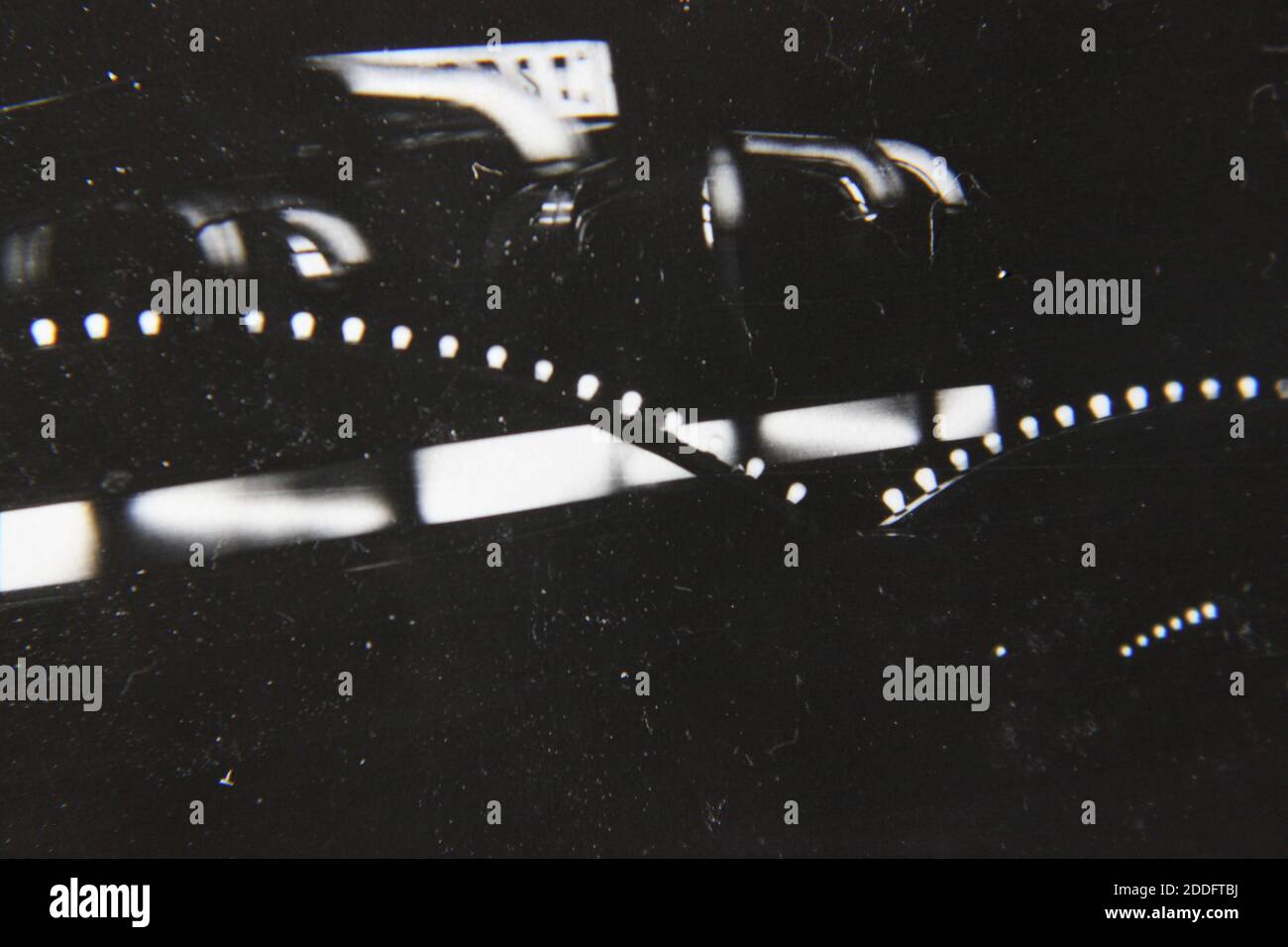 Fine 1970s vintage black and white photography of a carnival ride lit up at night with bright ...