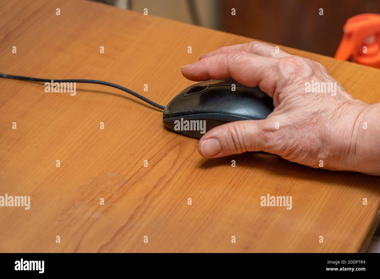 A woman uses a computer mouse. Female hand on a black computer mouse ...