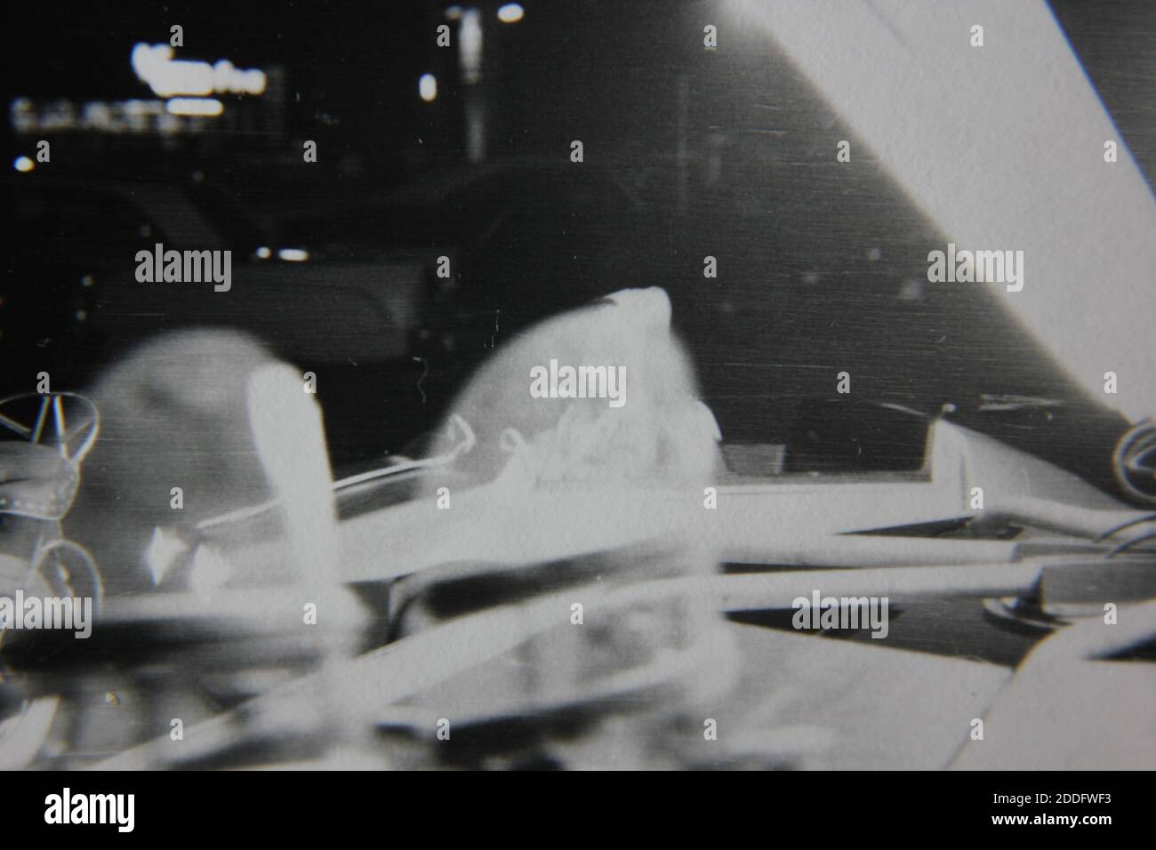 Fine 1970s vintage black and white photography of a carnival ride lit up at night with bright ...