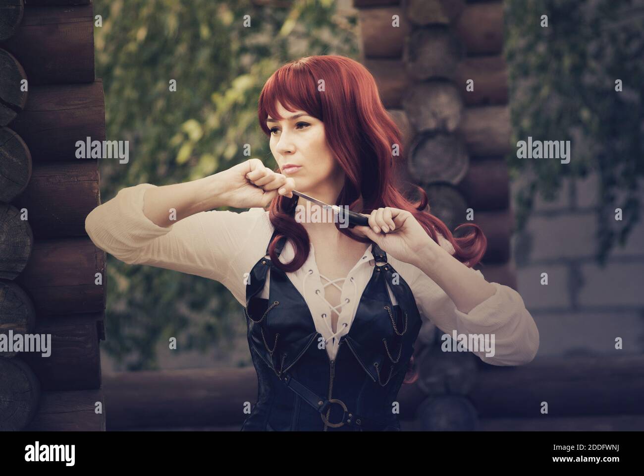 woman with red long hair robber lives in the forest Stock Photo - Alamy