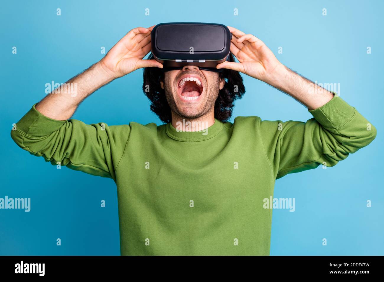 Photo of crazy funky man open mouth have fun wear headset green sweater ...