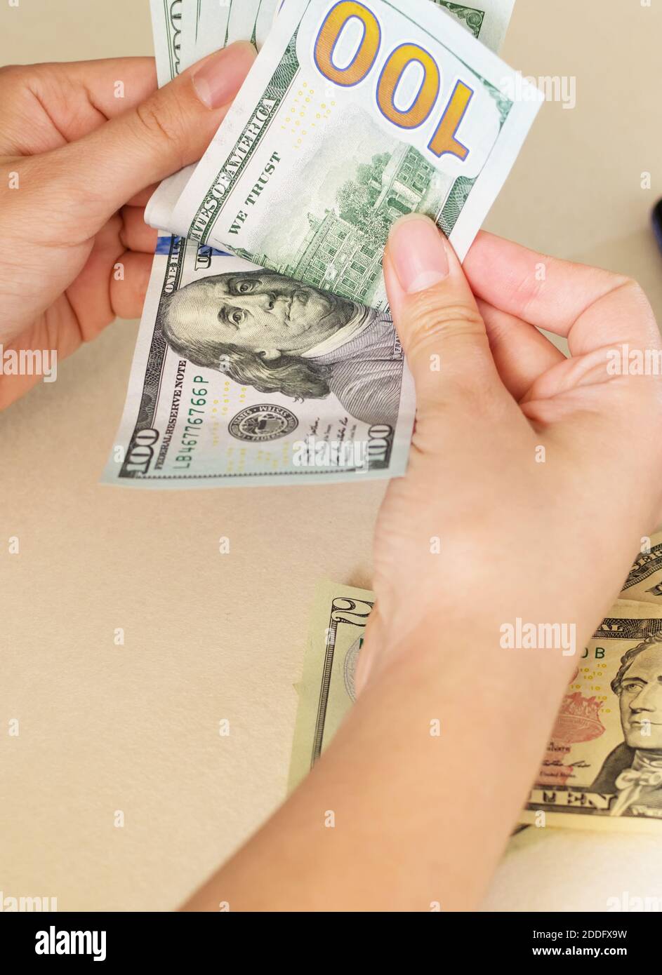 Womans hands counting dollar bills hi-res stock photography and images ...