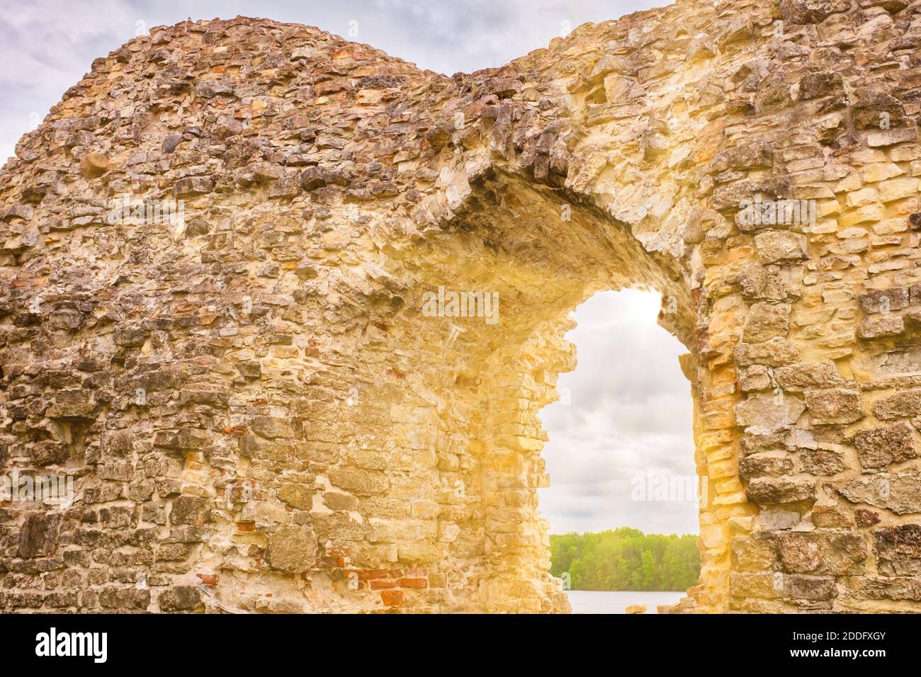An old castle ruin window, sunlight shines through the window frame ...