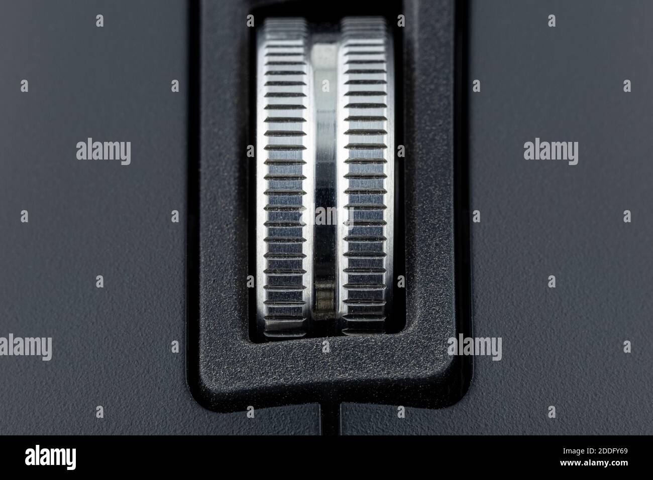A macro shot of a metal roller from a modern wireless computer mouse ...