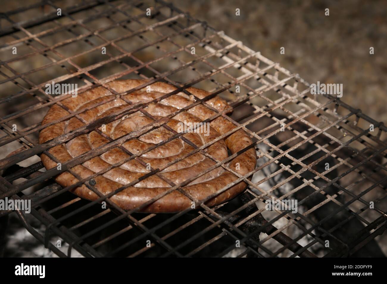The grilling process of boerewors sausage coils Stock Photo - Alamy