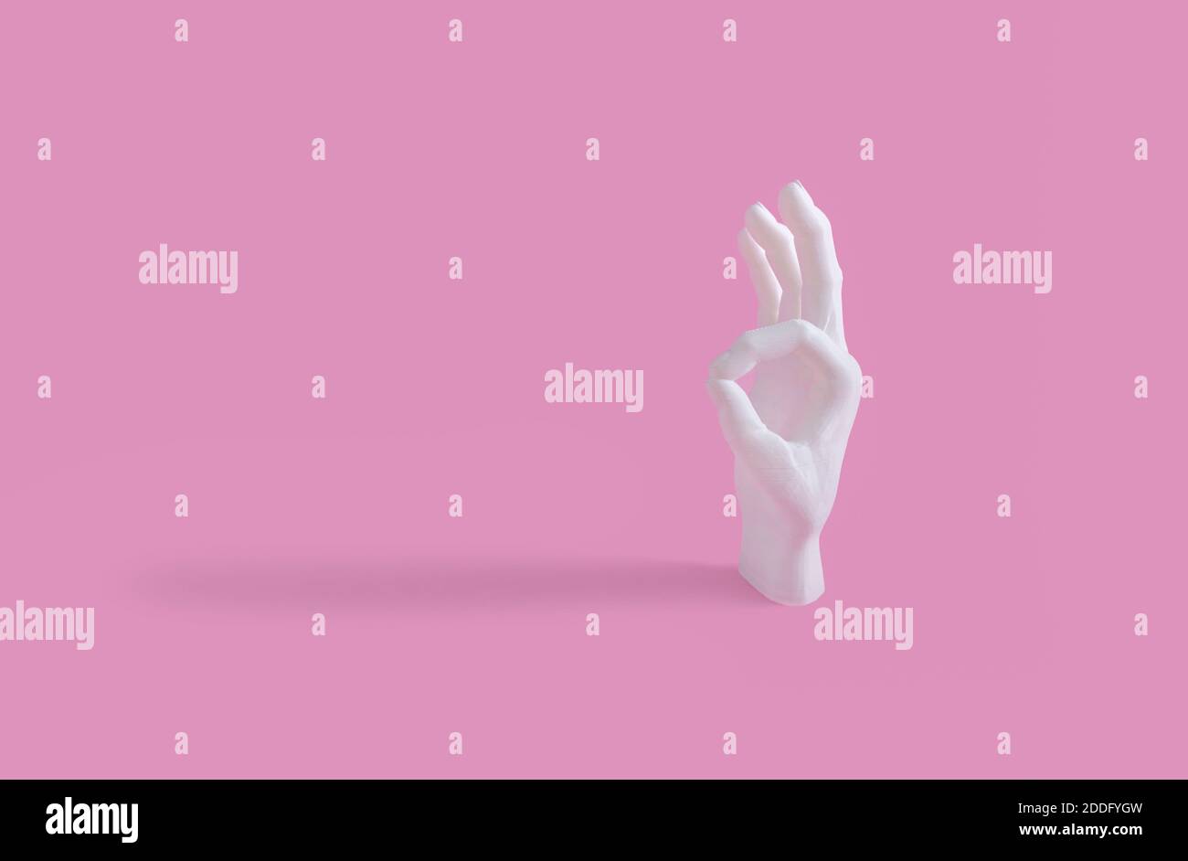 A human hand showing accepting okay hand sign gesture on pastel pink ...