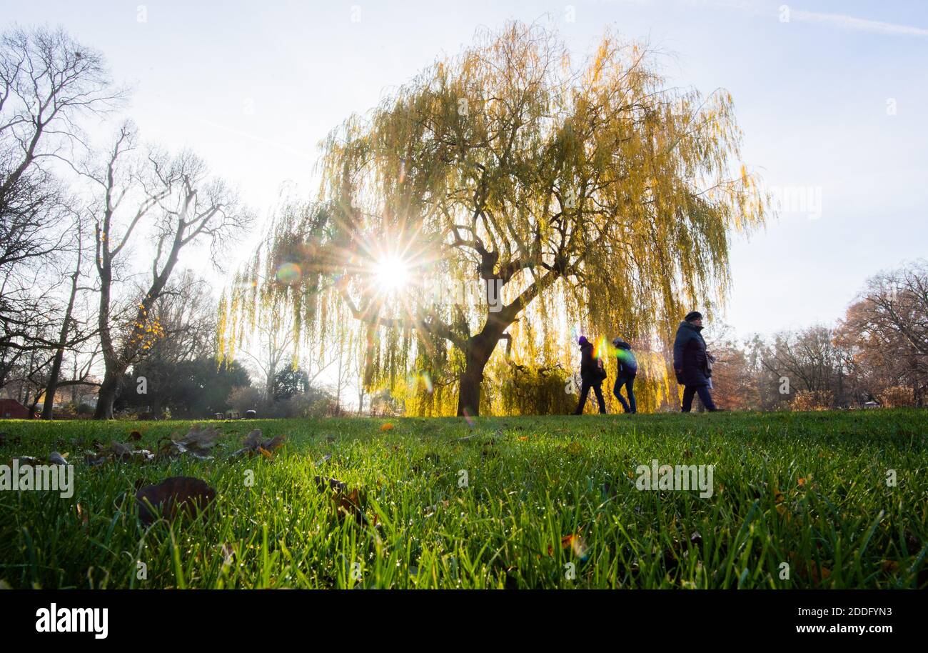 Hanover, Germany. 25th Nov, 2020. Passers-by walk in the sunshine in ...