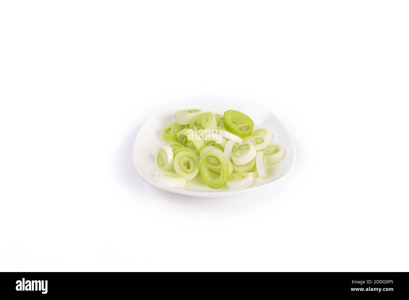 A plate of sliced scallions isolated on a white background Stock Photo ...