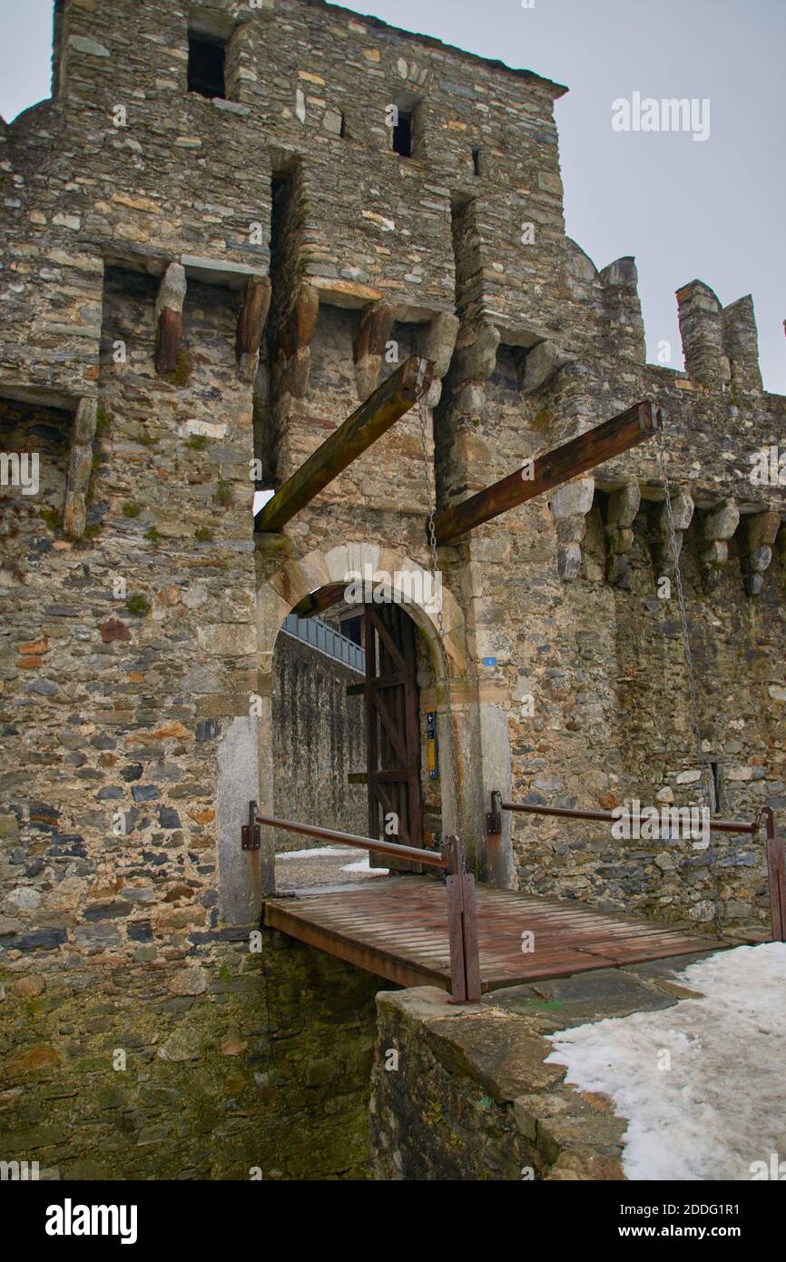 A vertical shot of the Bellinzona castle under a cloudy sky at daylight ...