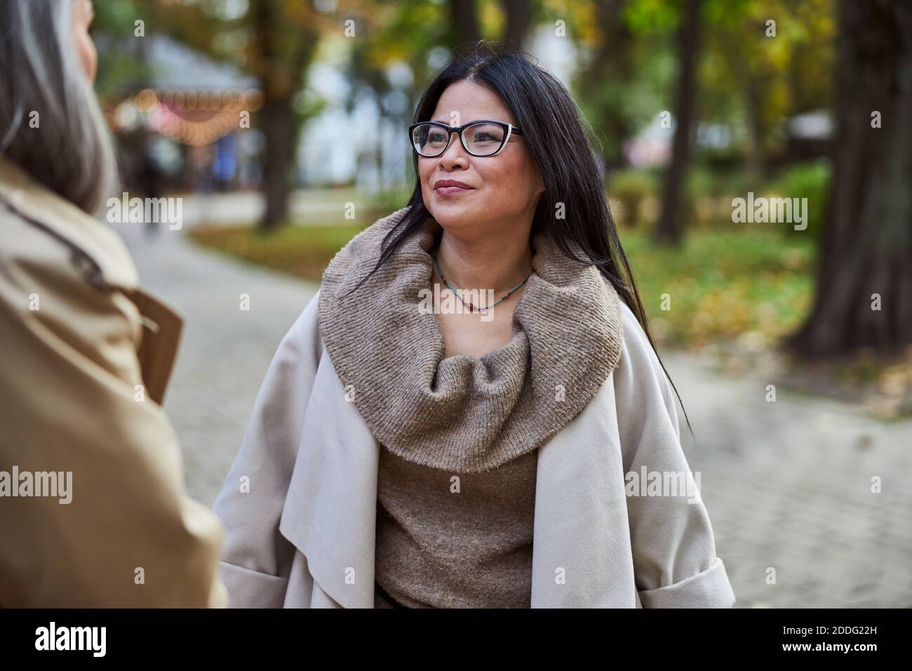 Beautiful joyful woman talking with friend on the street Stock Photo ...