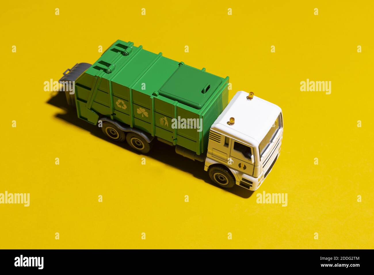 A green toy truck on yellow surface Stock Photo - Alamy