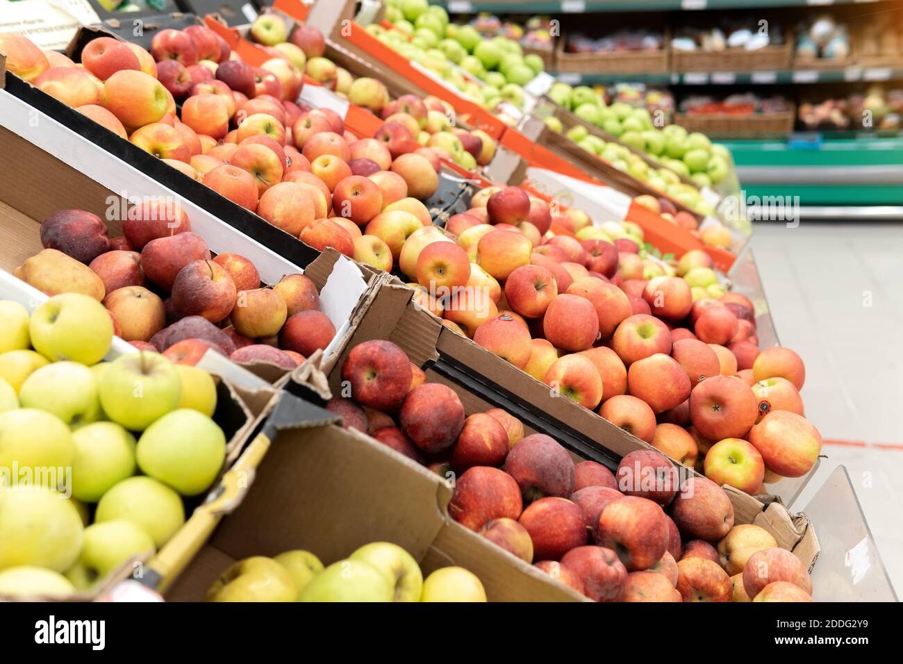 assortment of apples on the shelves of a grocery hypermarket. fresh ...