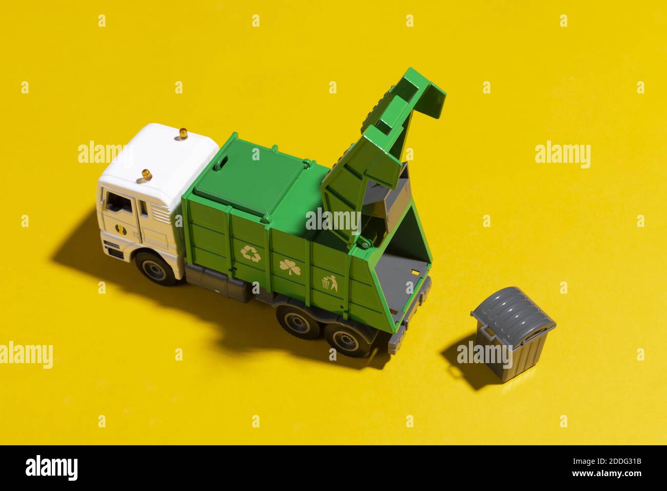 A green toy truck on yellow surface Stock Photo - Alamy