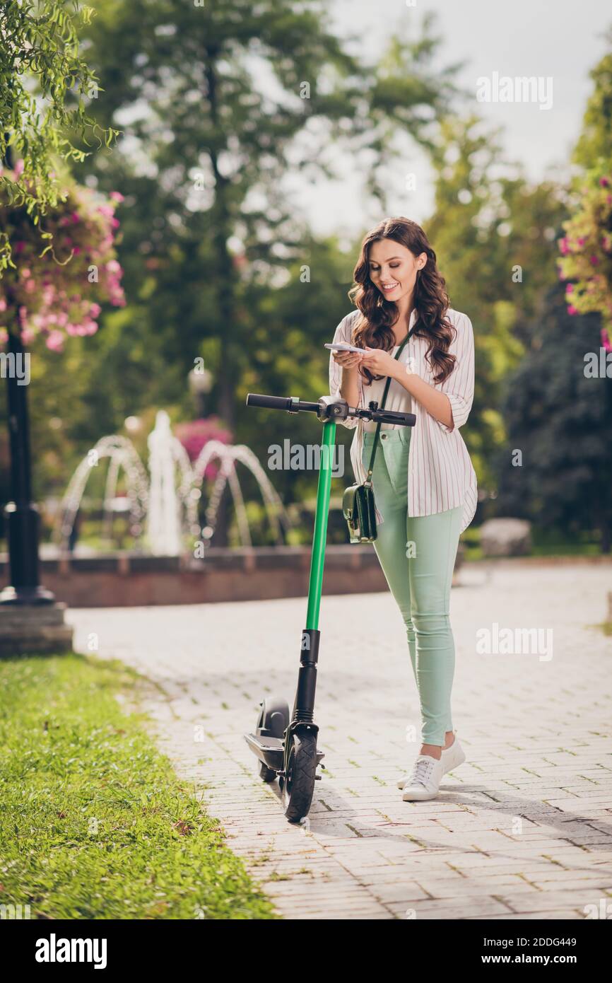 Vertical full size photo of cheerful wavy hair lady scan segway by ...