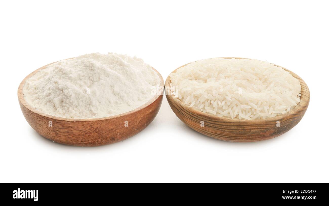Plates with rice and flour on white background Stock Photo - Alamy