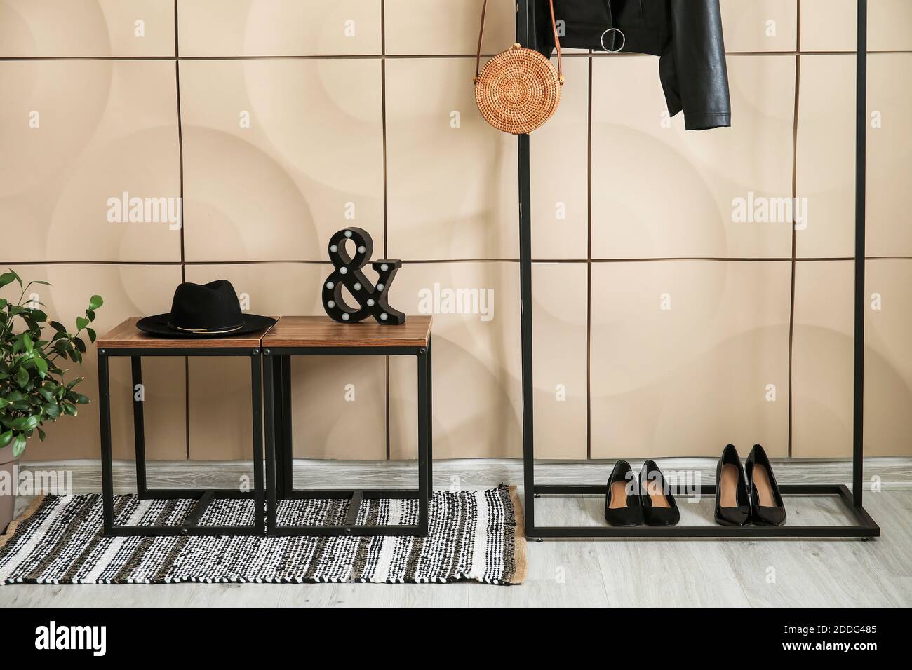 Stylish interior of modern hall with table and clothes rack Stock Photo ...