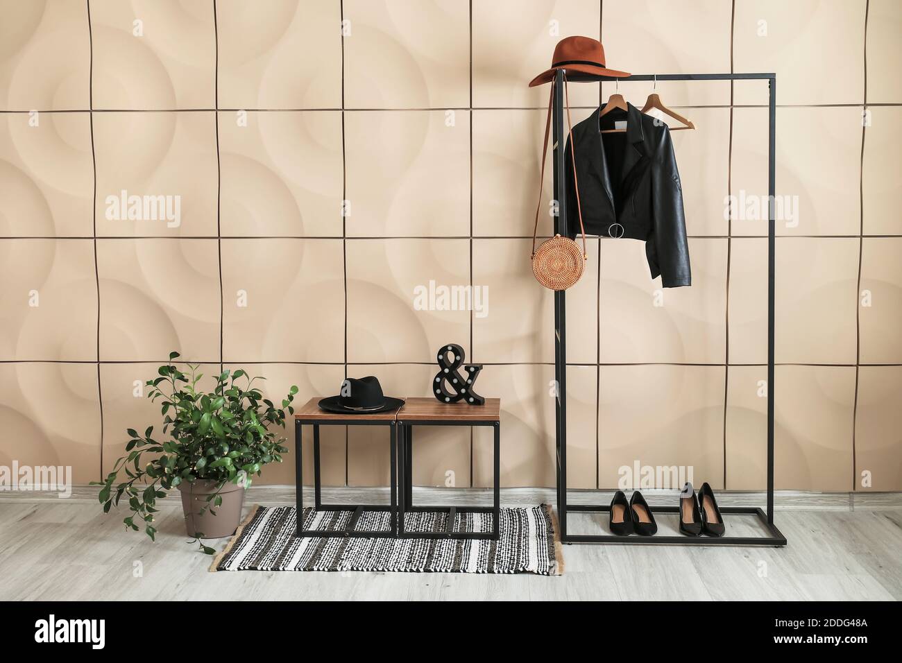 Stylish interior of modern hall with table and clothes rack Stock Photo ...