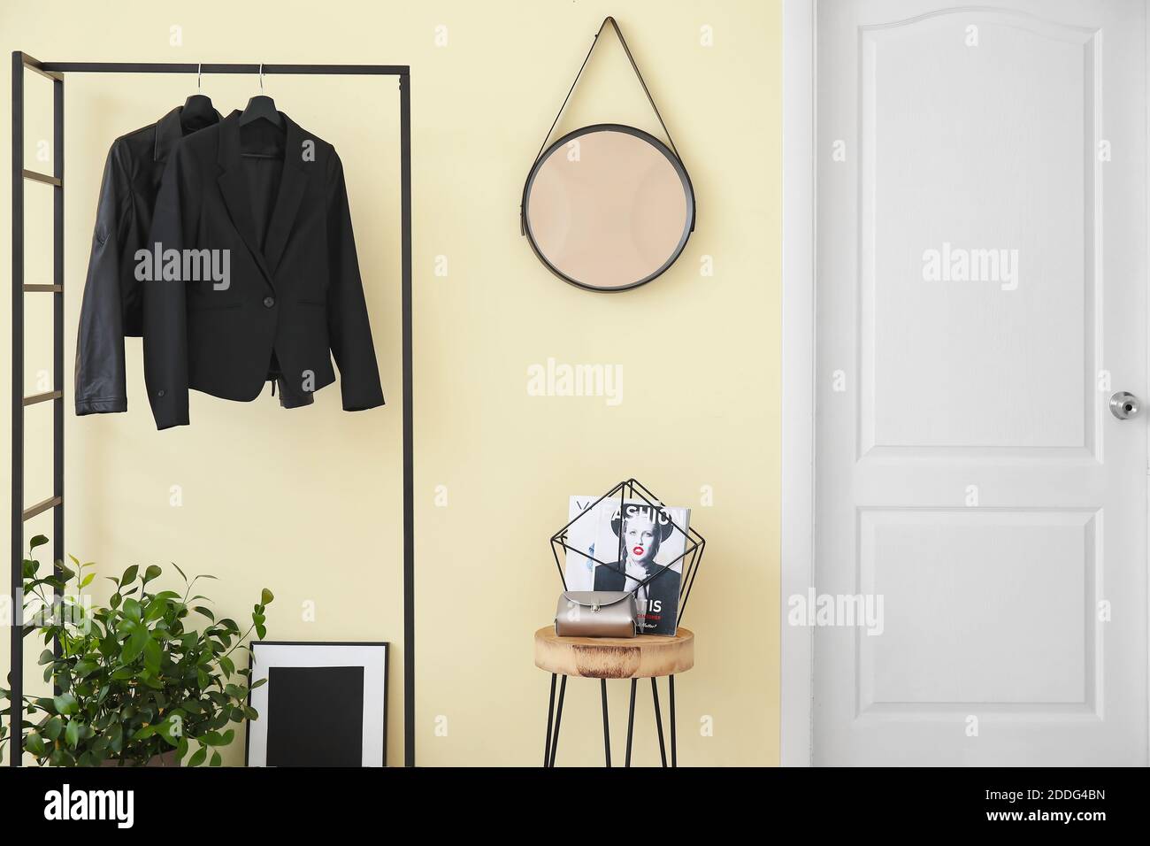 Stylish interior of modern hall with table and clothes rack Stock Photo ...