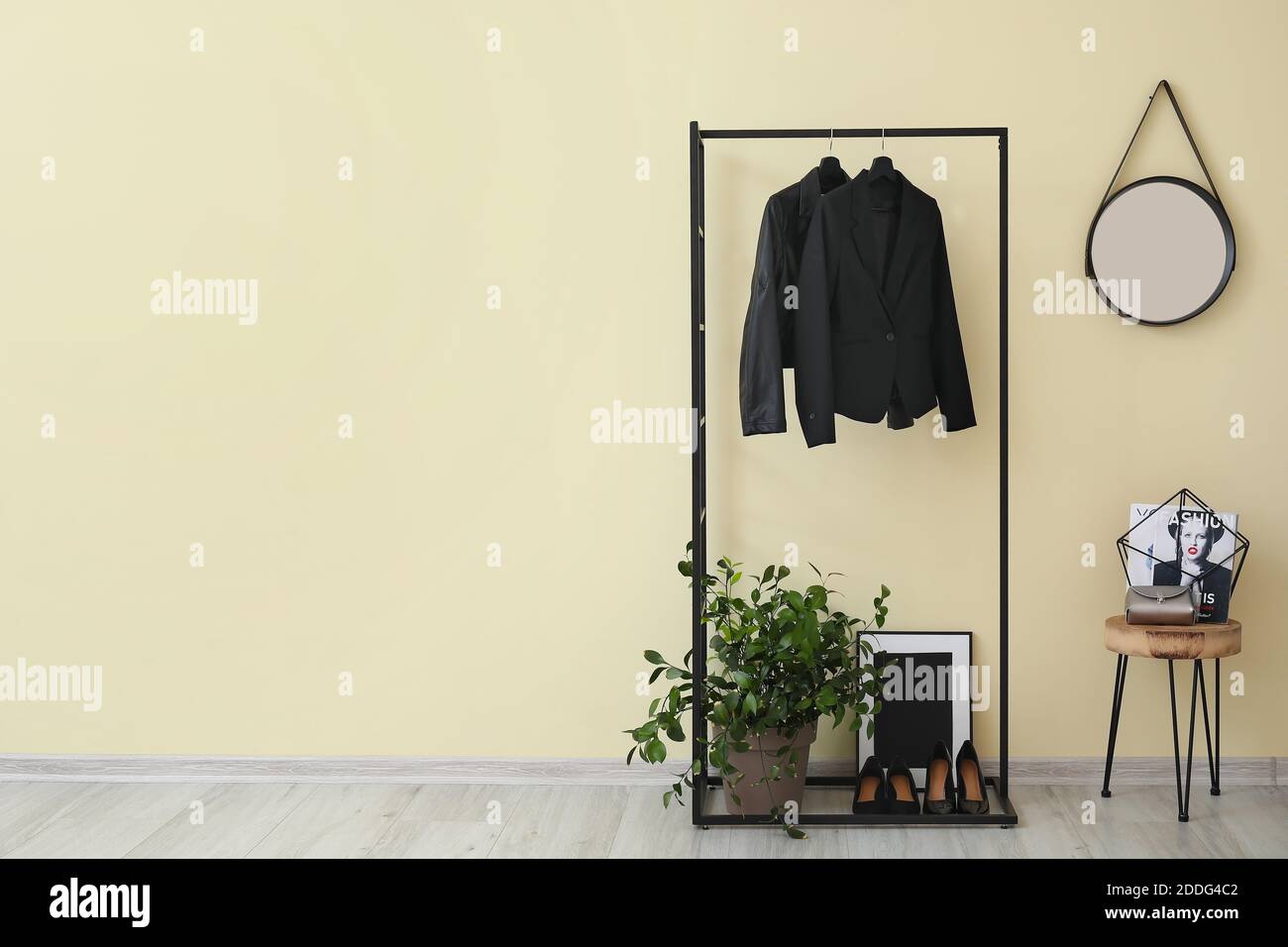 Stylish interior of modern hall with table and clothes rack Stock Photo ...