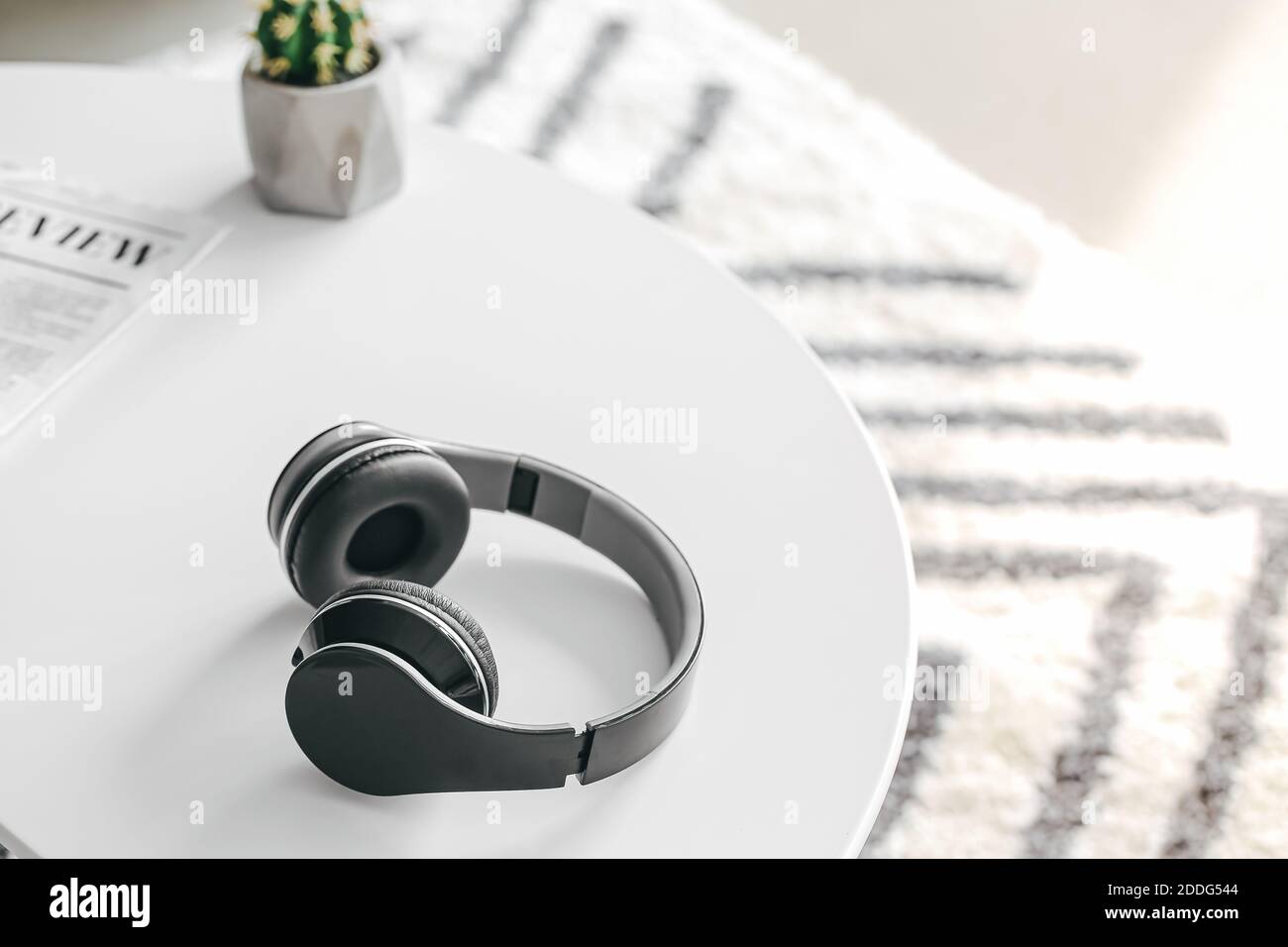 Modern headphones on table in room Stock Photo - Alamy