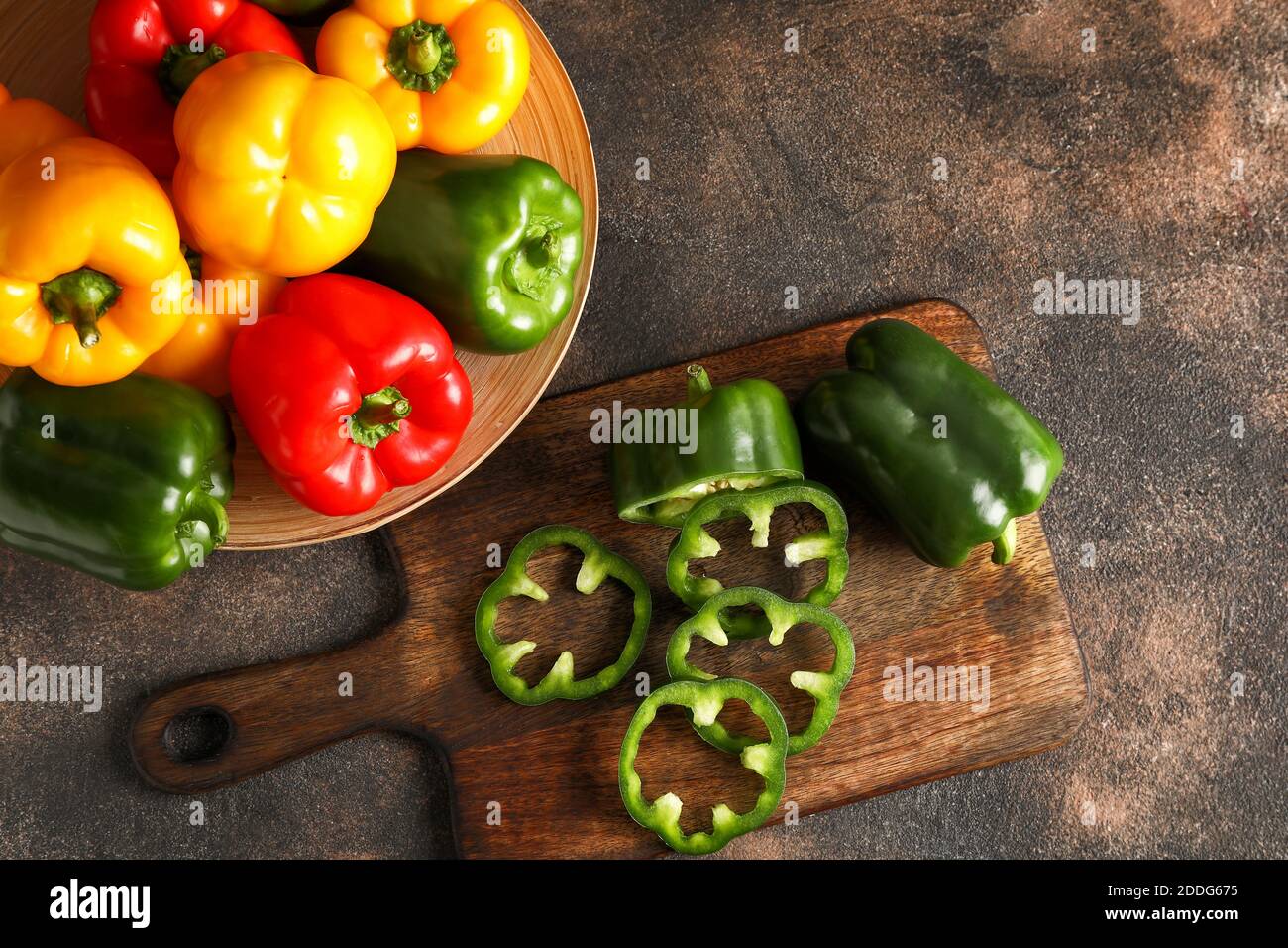 Composition with fresh bell peppers on table Stock Photo - Alamy