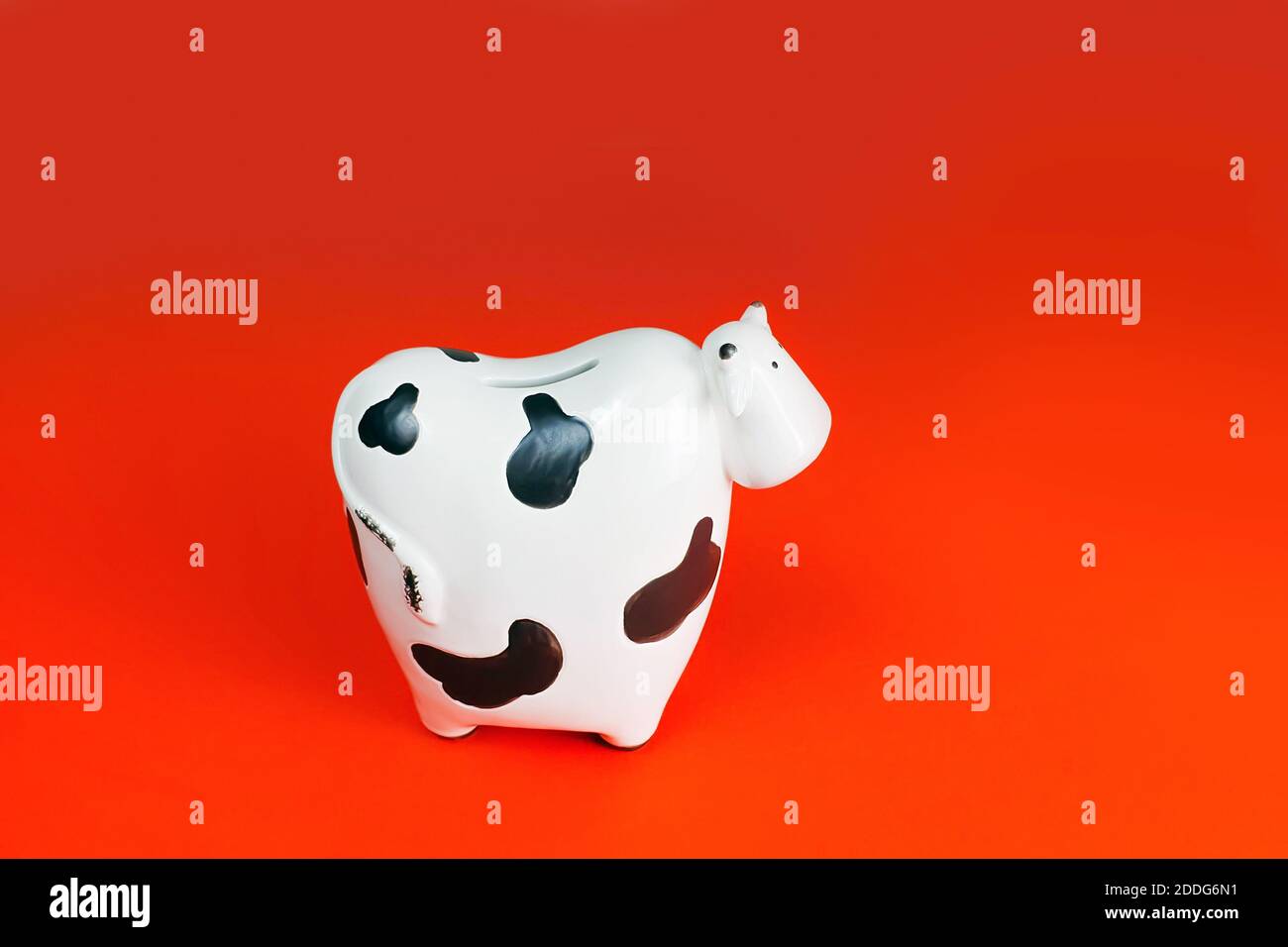 money box cow on red background Stock Photo - Alamy