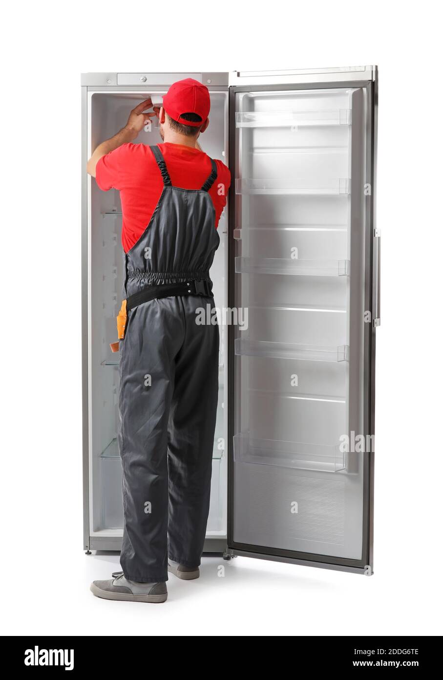 Worker repairing fridge on white background Stock Photo - Alamy