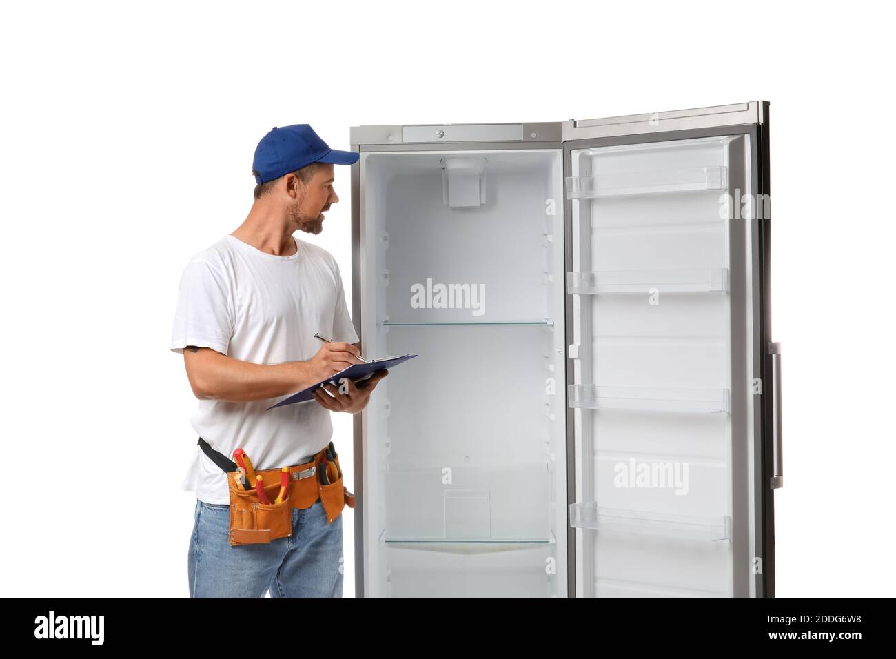 Worker of repair service near fridge on white background Stock Photo ...