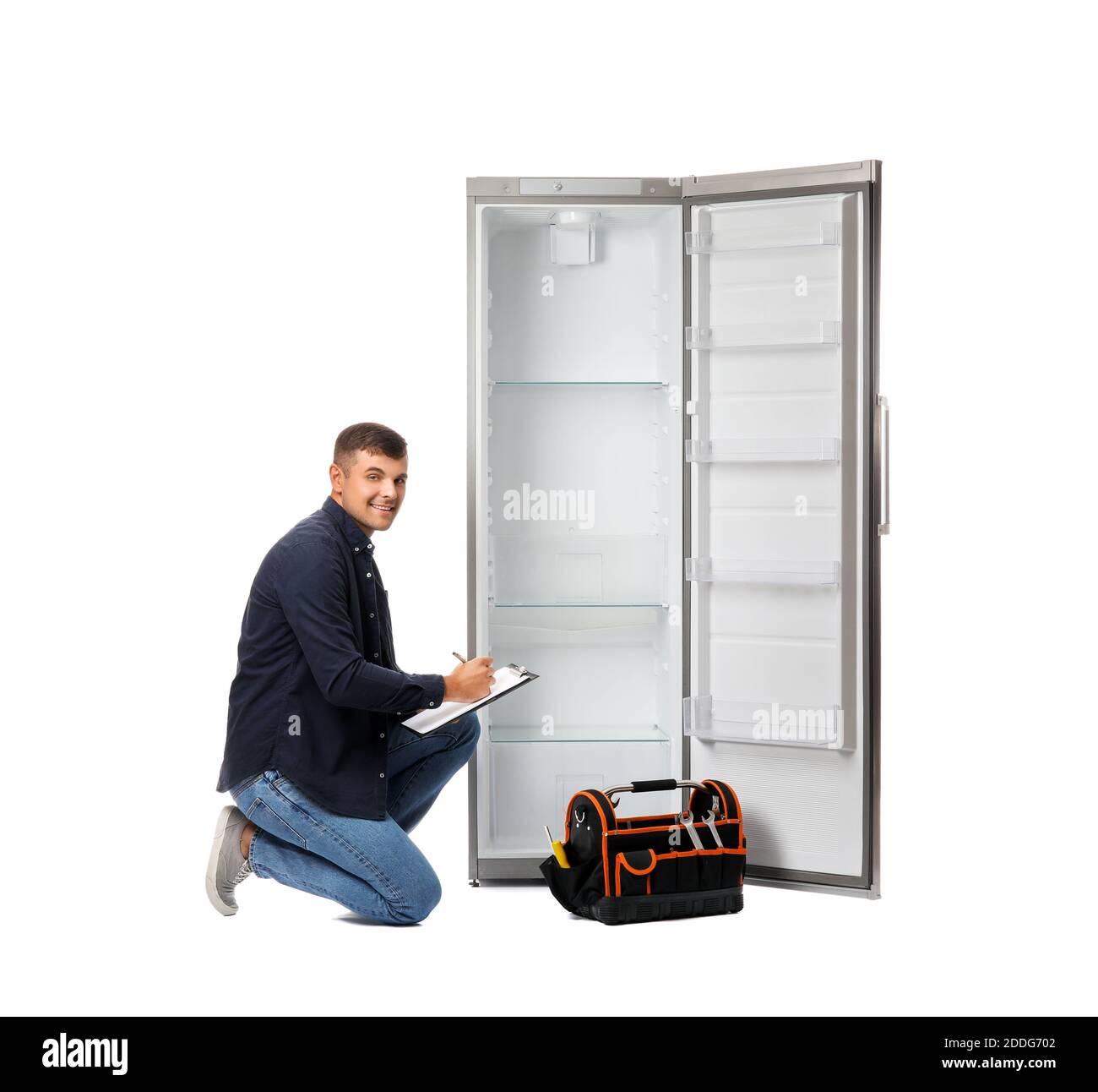 Worker of repair service near fridge on white background Stock Photo ...